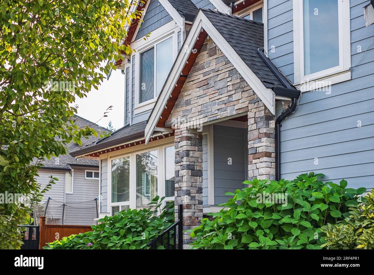 Entrance to a home through a beautiful garden with colorful flowers ...