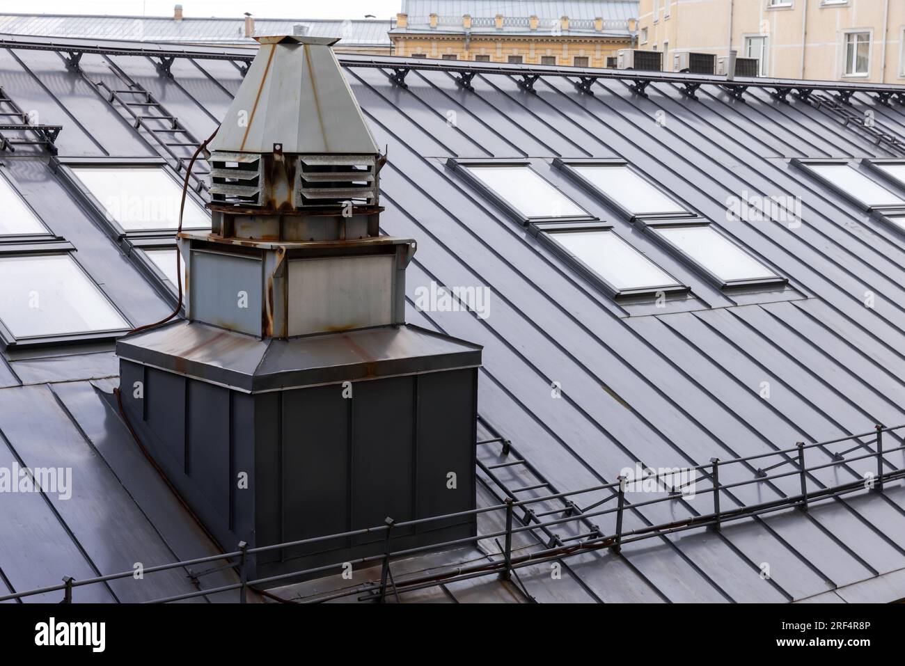 Metal roof with ventilation shafts and attic windows, modern ...
