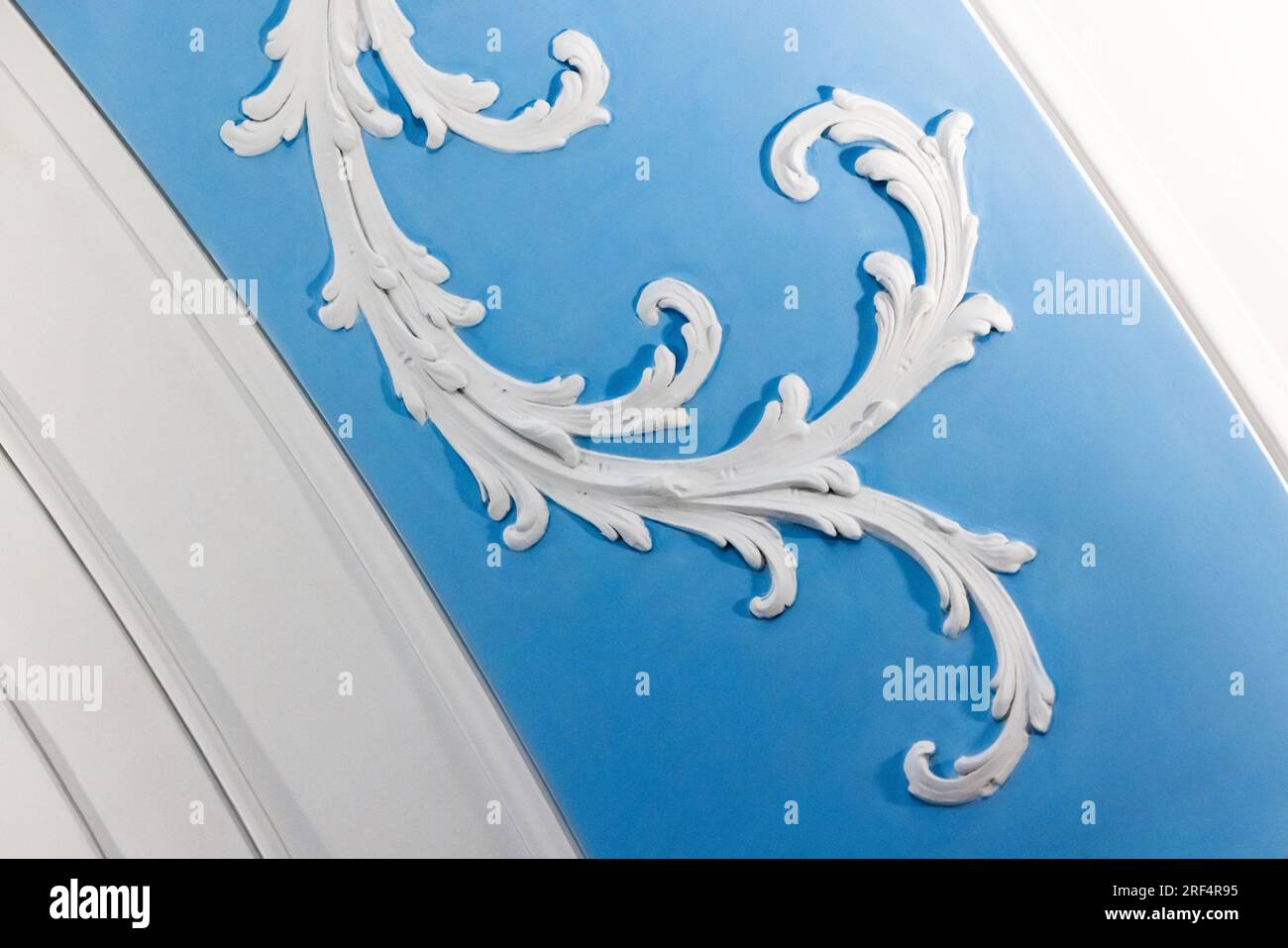 White bas-relief over blue background, wall design gypsum details in ...