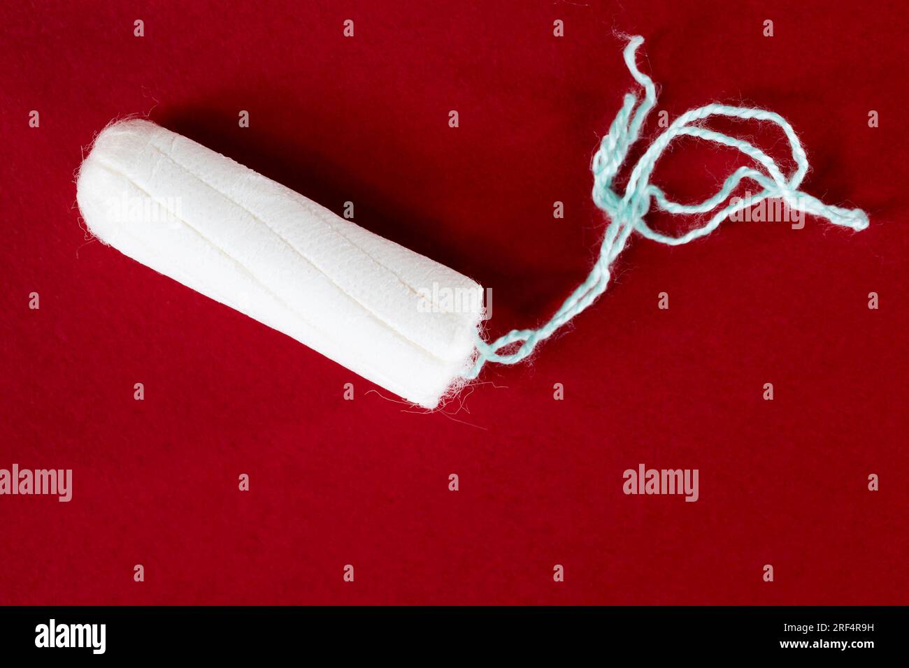 women's sanitary tampon on a red background, sanitary tampon made of ...