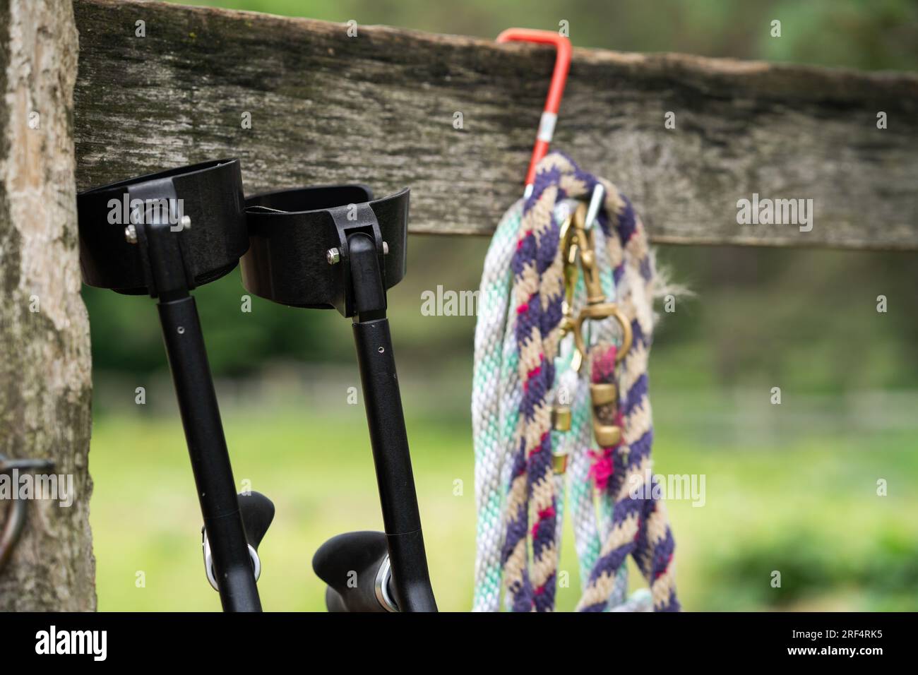 Red forearm crutches and lead ropes on a paddock fence Stock Photo - Alamy