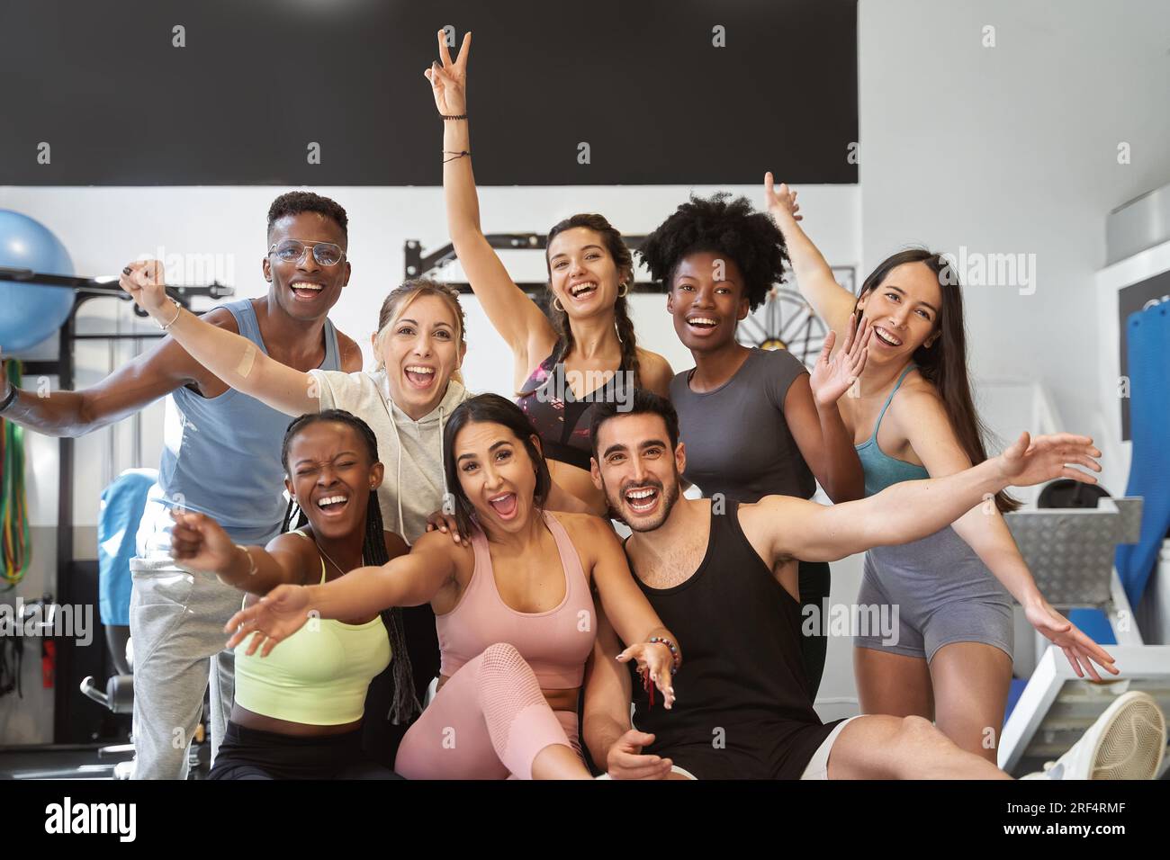 multicultural group of fitness people looking at camera and smiling at ...