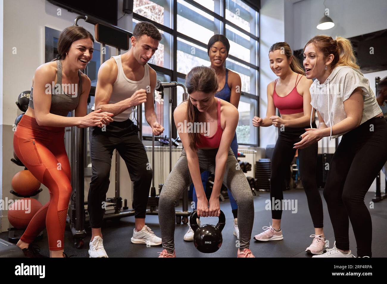 Supportive Group of Friends Encouraging and Cheering On a Woman as She ...