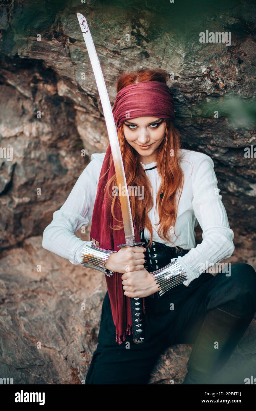 Outdoor portrait of young female in pirate costume with a sword Stock ...
