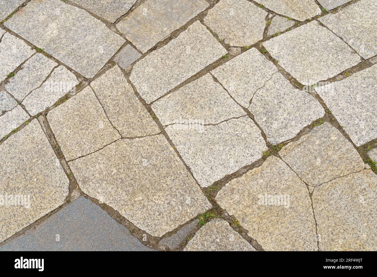 Texture of old cracked gray granite paving slabs Stock Photo - Alamy