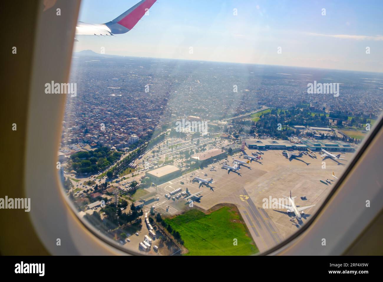 Looking through window aircraft during flight over Adana in sunny ...