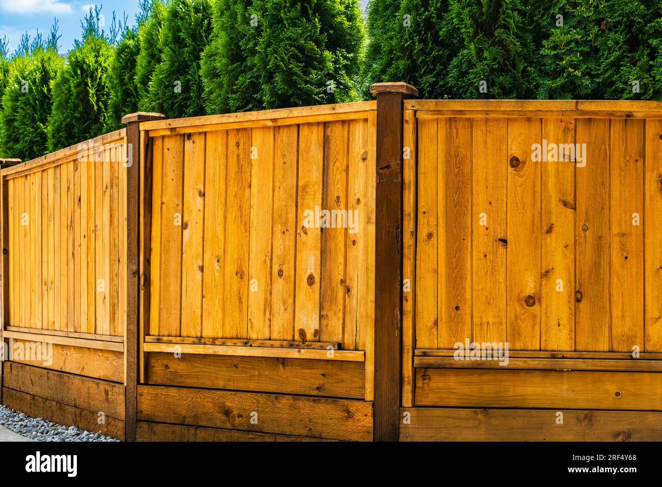 Beautiful new wooden fence around the house. New wooden fence with ...