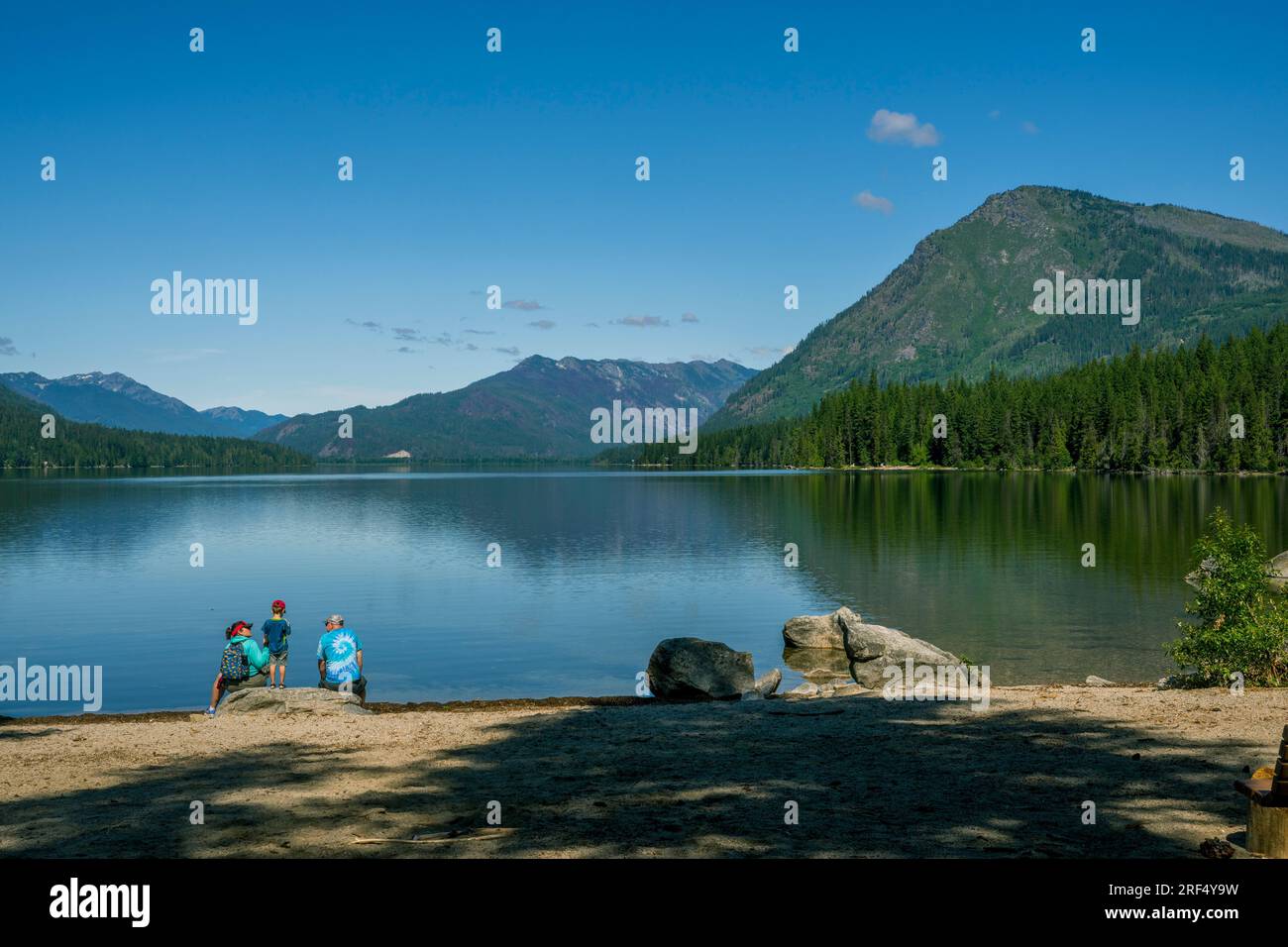 A family on a beach at Lake Wenatchee in the Lake Wenatchee State Park ...