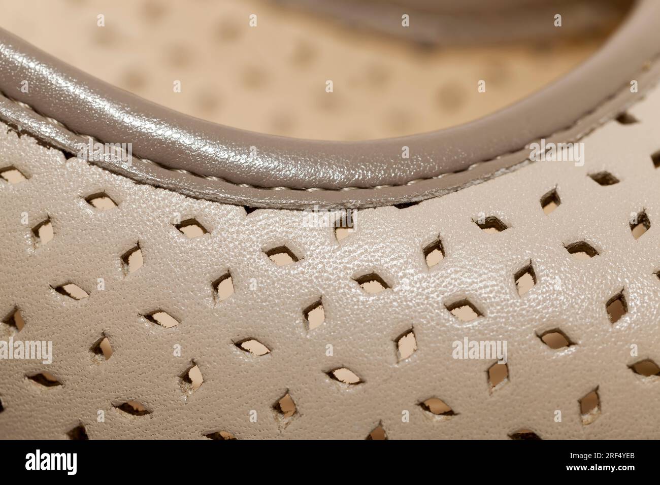 part of the leather shoes with holes for ventilation, part of the beige ...