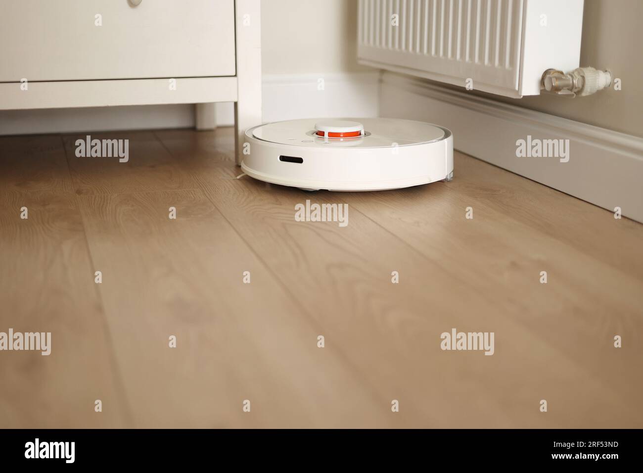 White wireless autonomous robotic vacuum cleaner with remote control ...