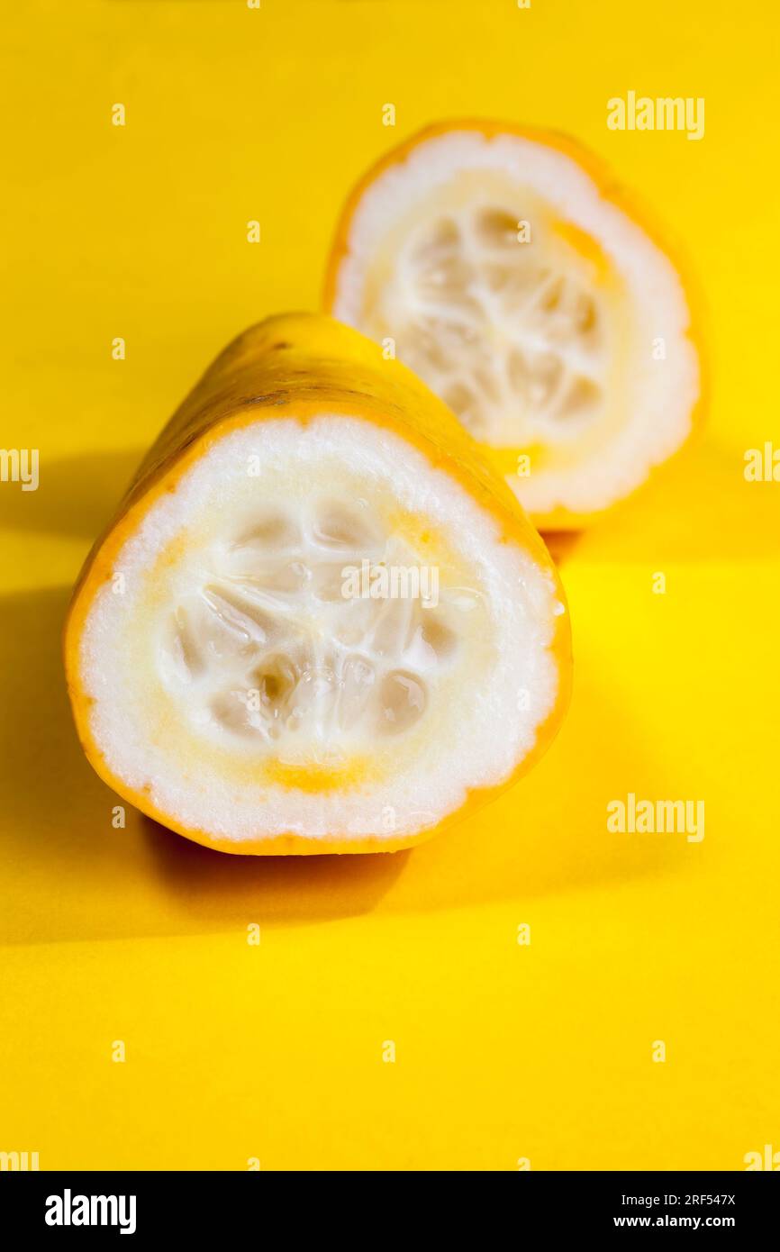 cut into half a ripe old cucumber, the seeds from which can be used to ...