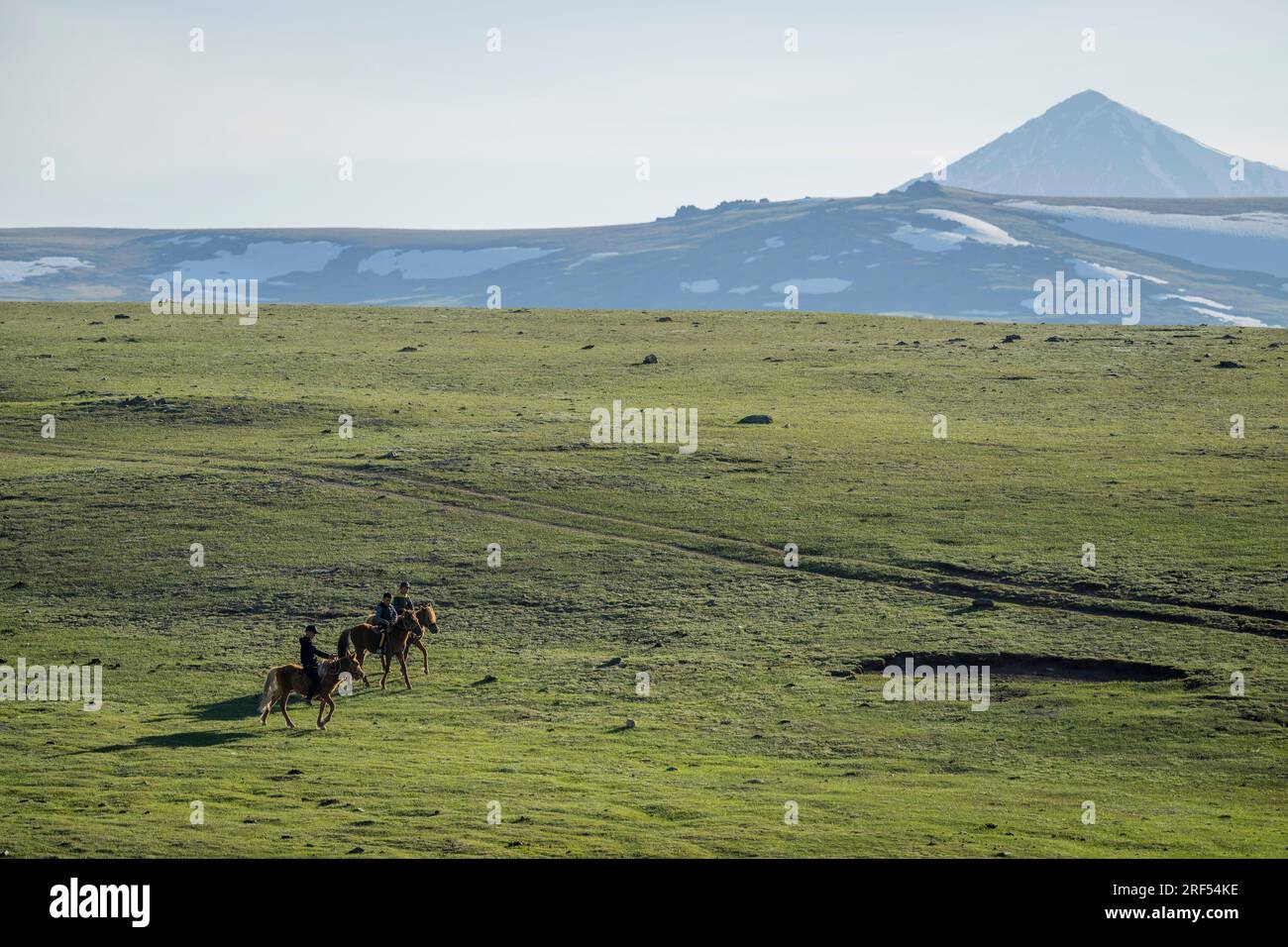 Local people on horseback in a remote valley in the Altai Mountains ...