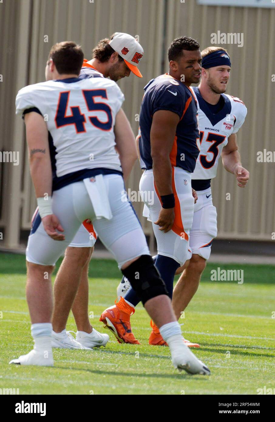 Denver Broncos quarterback Russell Wilson, second from right, talks ...