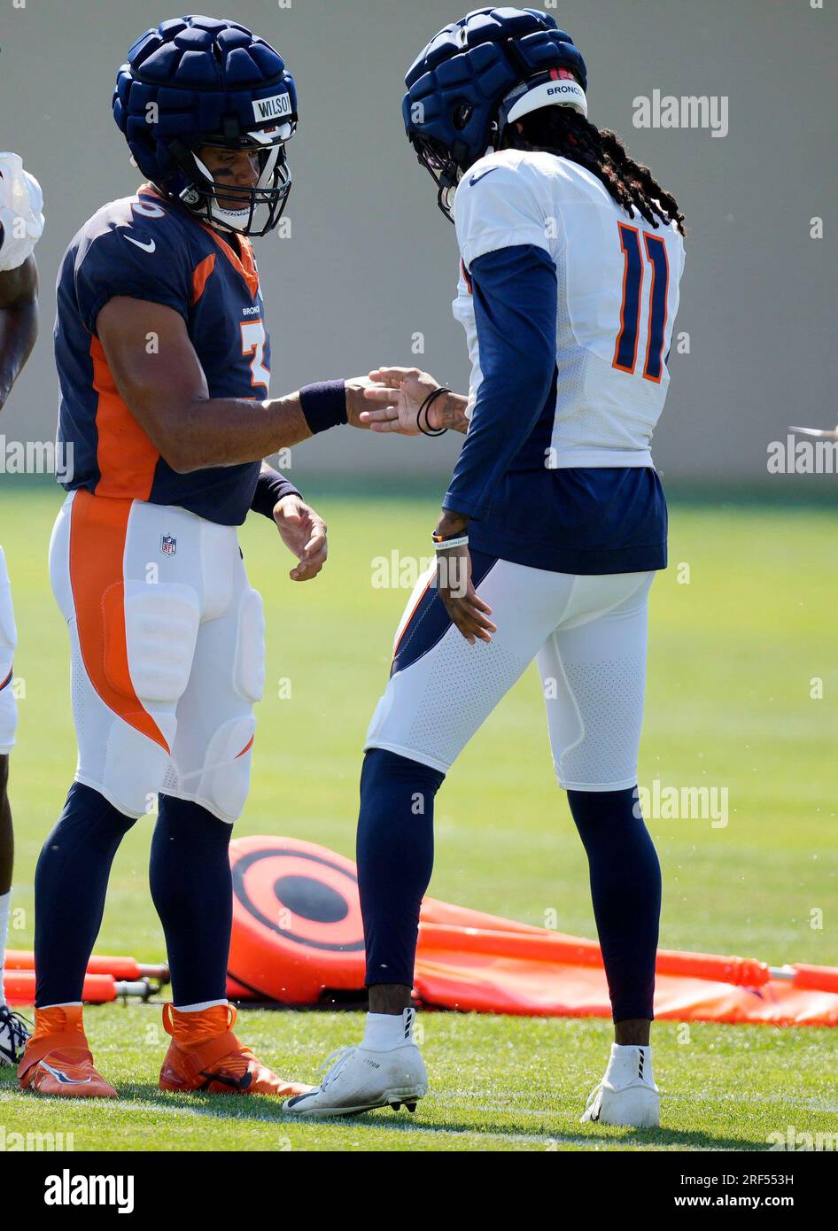 Denver Broncos quarterback Russell Wilson, left, greets wide receiver ...