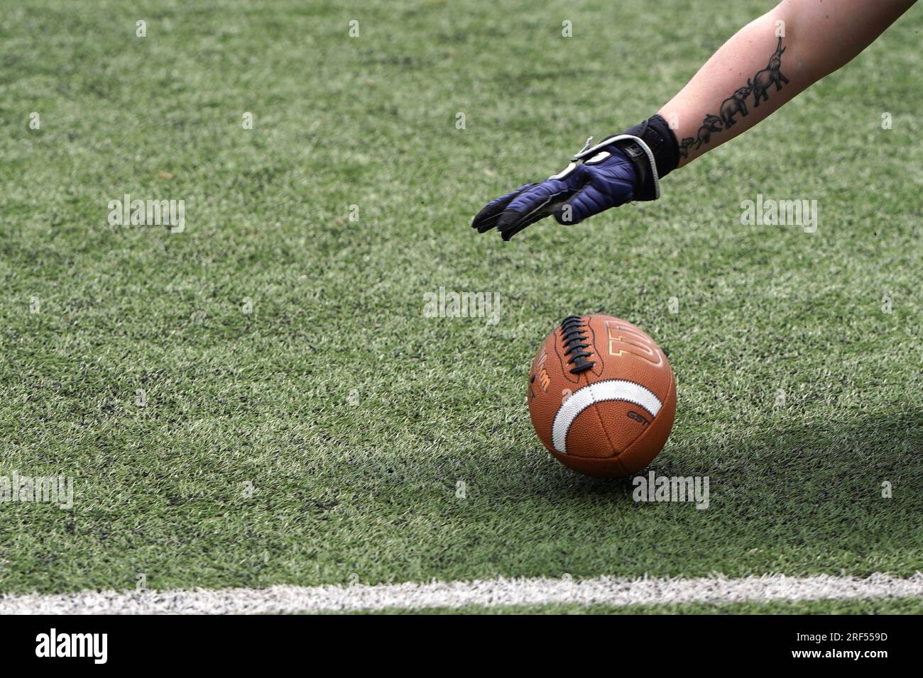 Chasing a bouncing American Football Stock Photo - Alamy