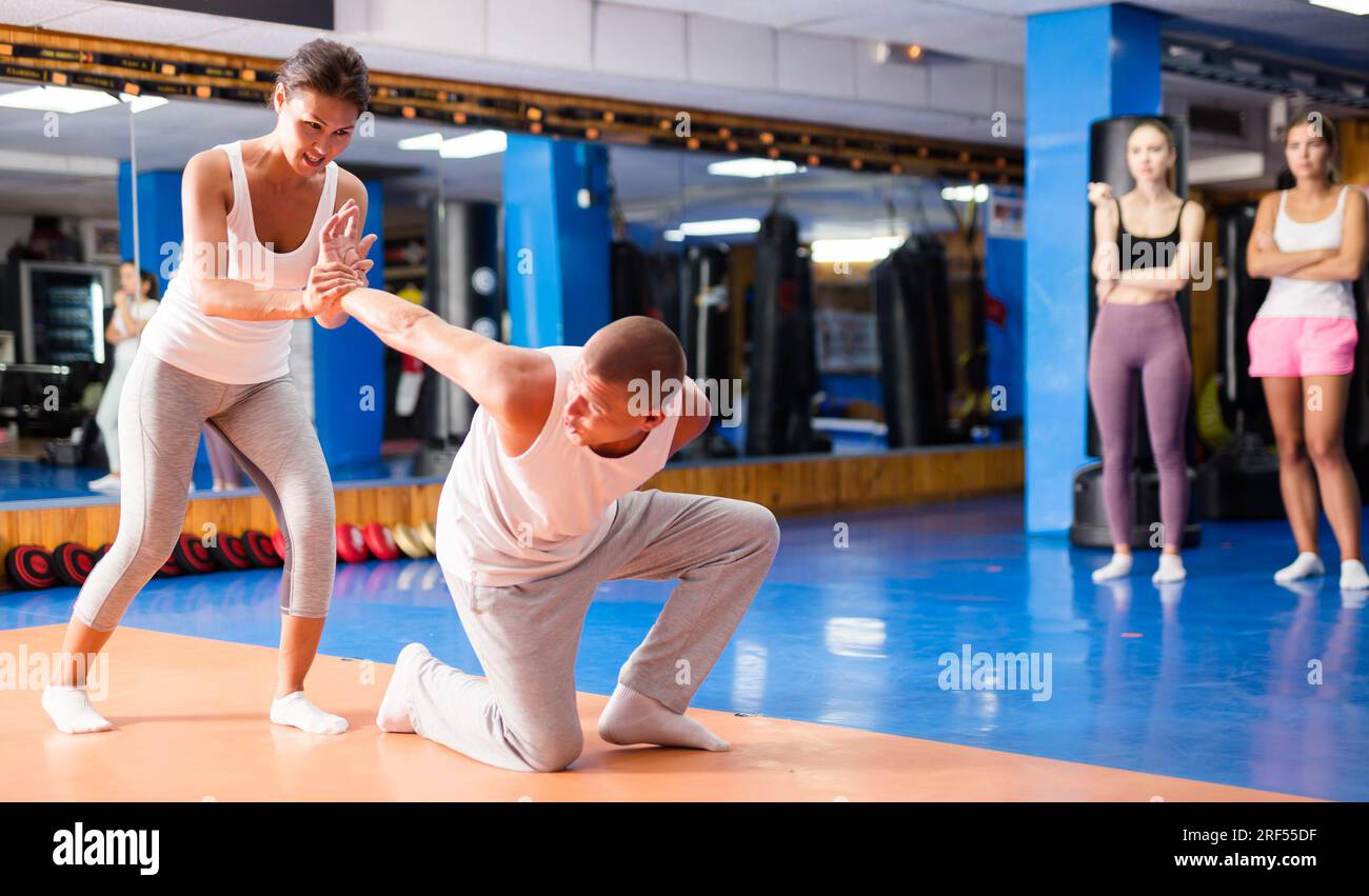 Asian woman practicing self-defence moves with her trainer Stock Photo ...