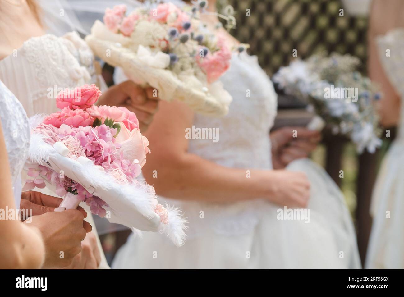 Many brides hold their wedding bouquet in their hands Stock Photo - Alamy