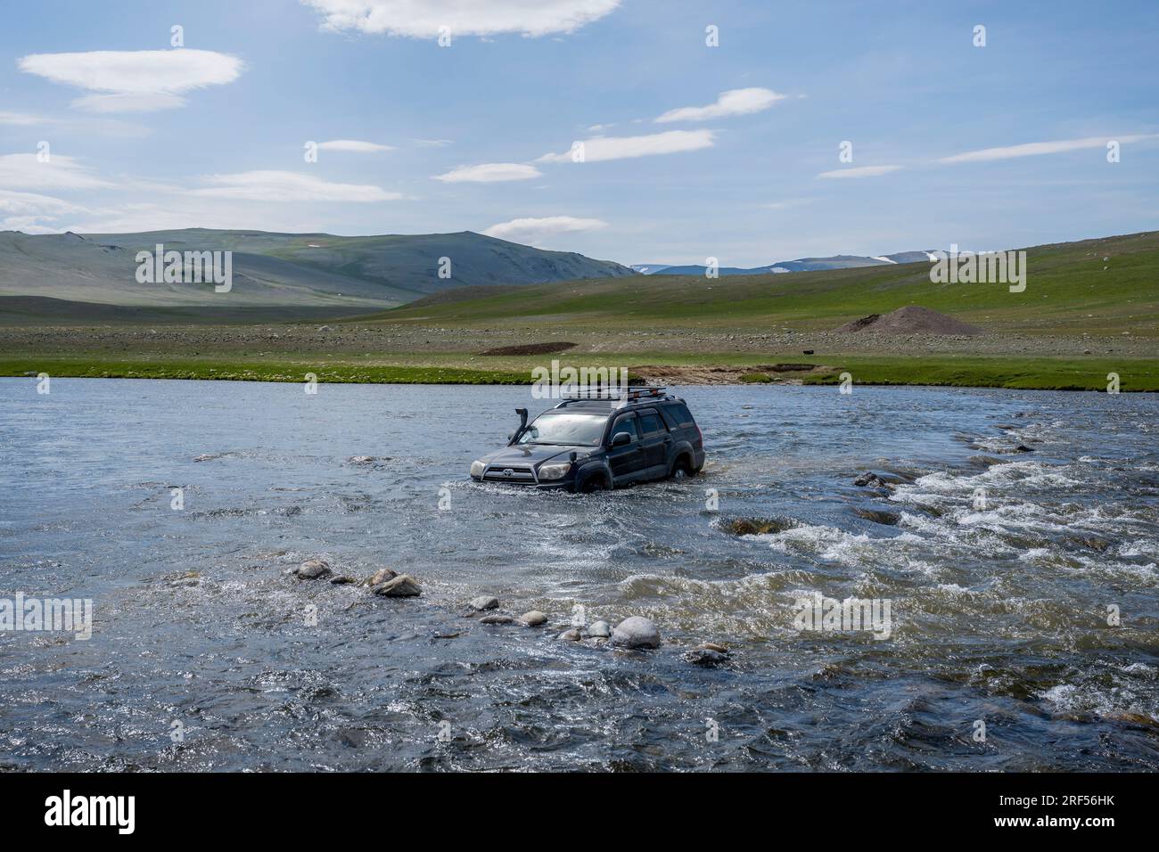 Toyota Land Cruisers crossing the Sagsai River in a remote valley in ...