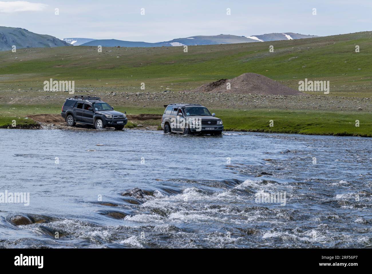 Toyota Land Cruisers crossing the Sagsai River in a remote valley in ...