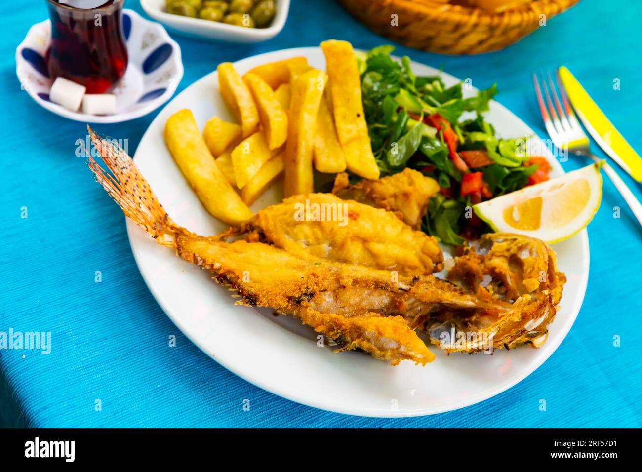 Fried lionfish served on white plate with vegetable garnish Stock Photo ...
