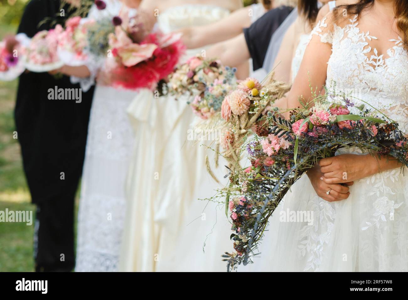 Many brides hold their wedding bouquet in their hands Stock Photo - Alamy