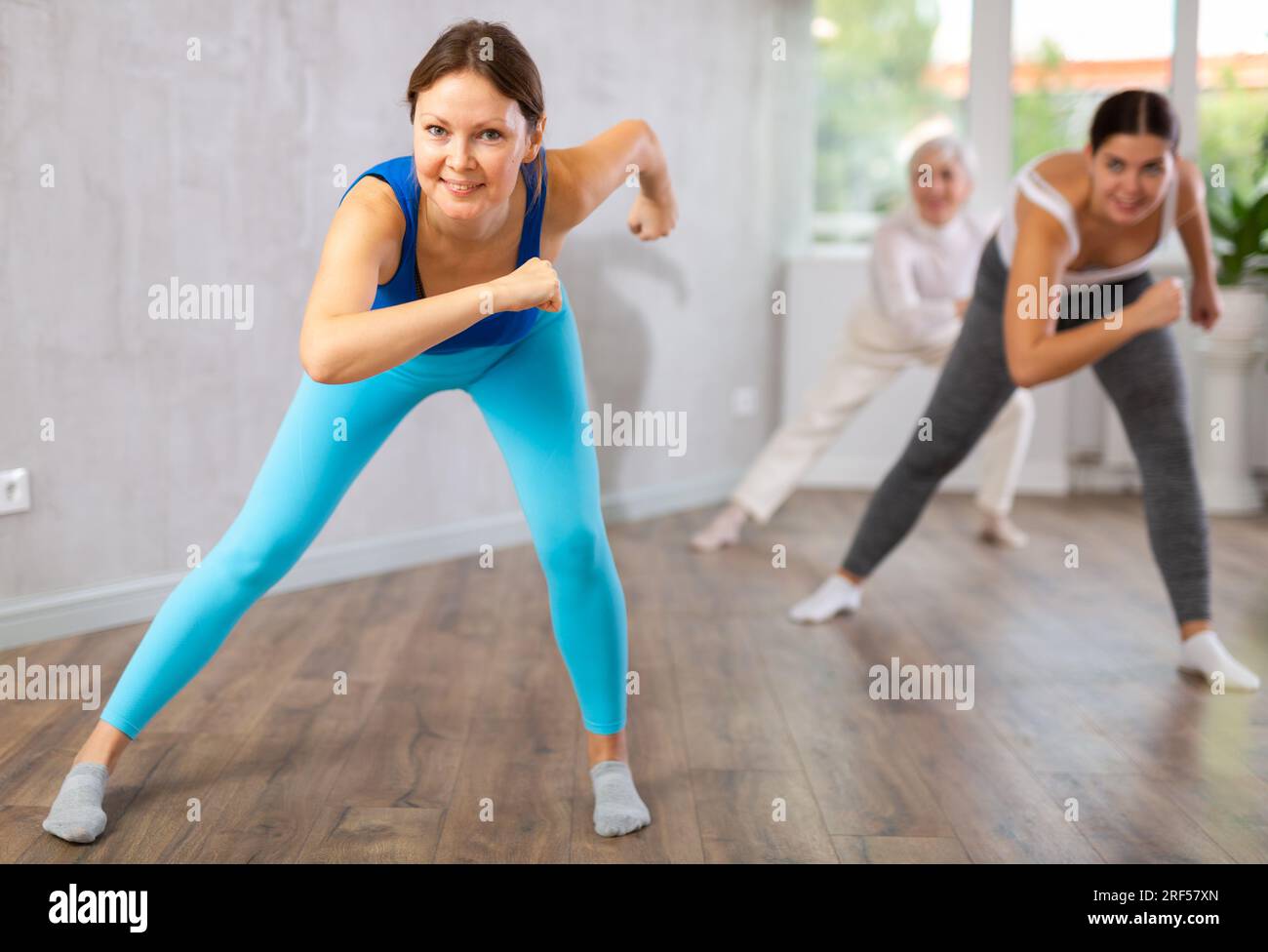 Positive women engaged in active dancing Stock Photo - Alamy