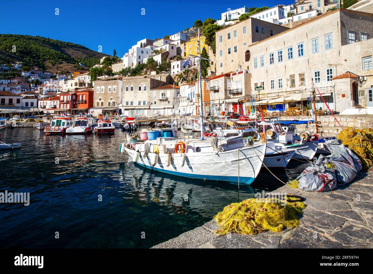 Fishing and recreational boats in harbor of Hydra island. Houses of ...