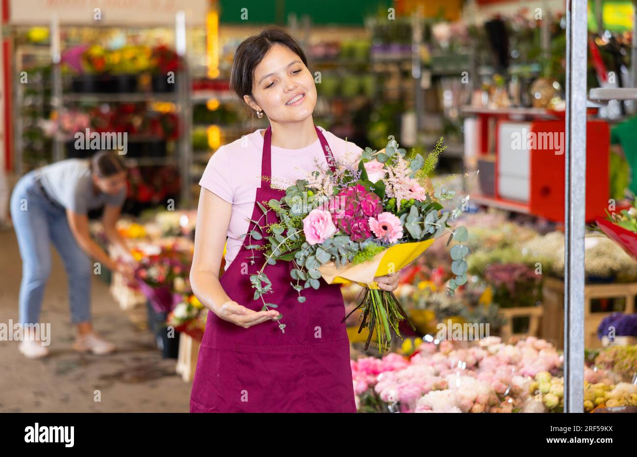 Portrait of female flower market seller with bouquets of flowers Stock ...