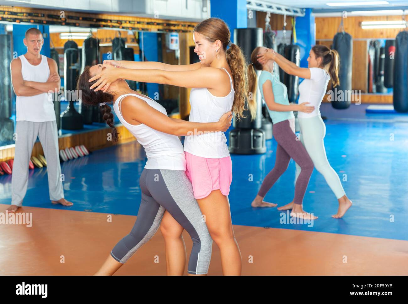 Sporty girls in pairs are training self-defence moves Stock Photo - Alamy