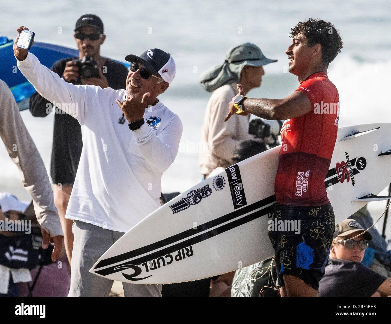 Samuel Pupo takes a photo with a fan at the US Open of Surfing in ...
