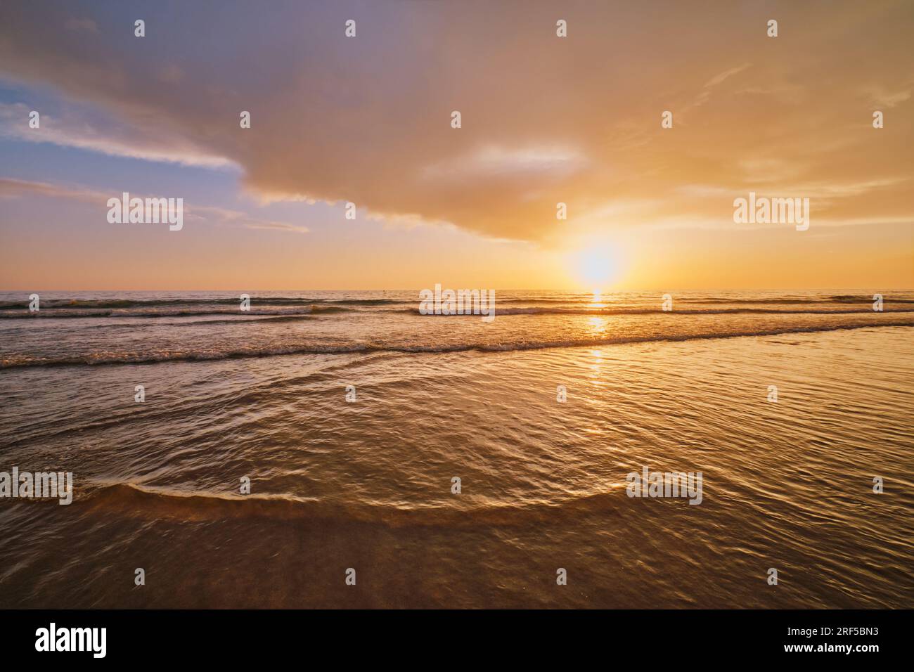 Atlantic ocean sunset with surging waves at Fonte da Telha beach ...