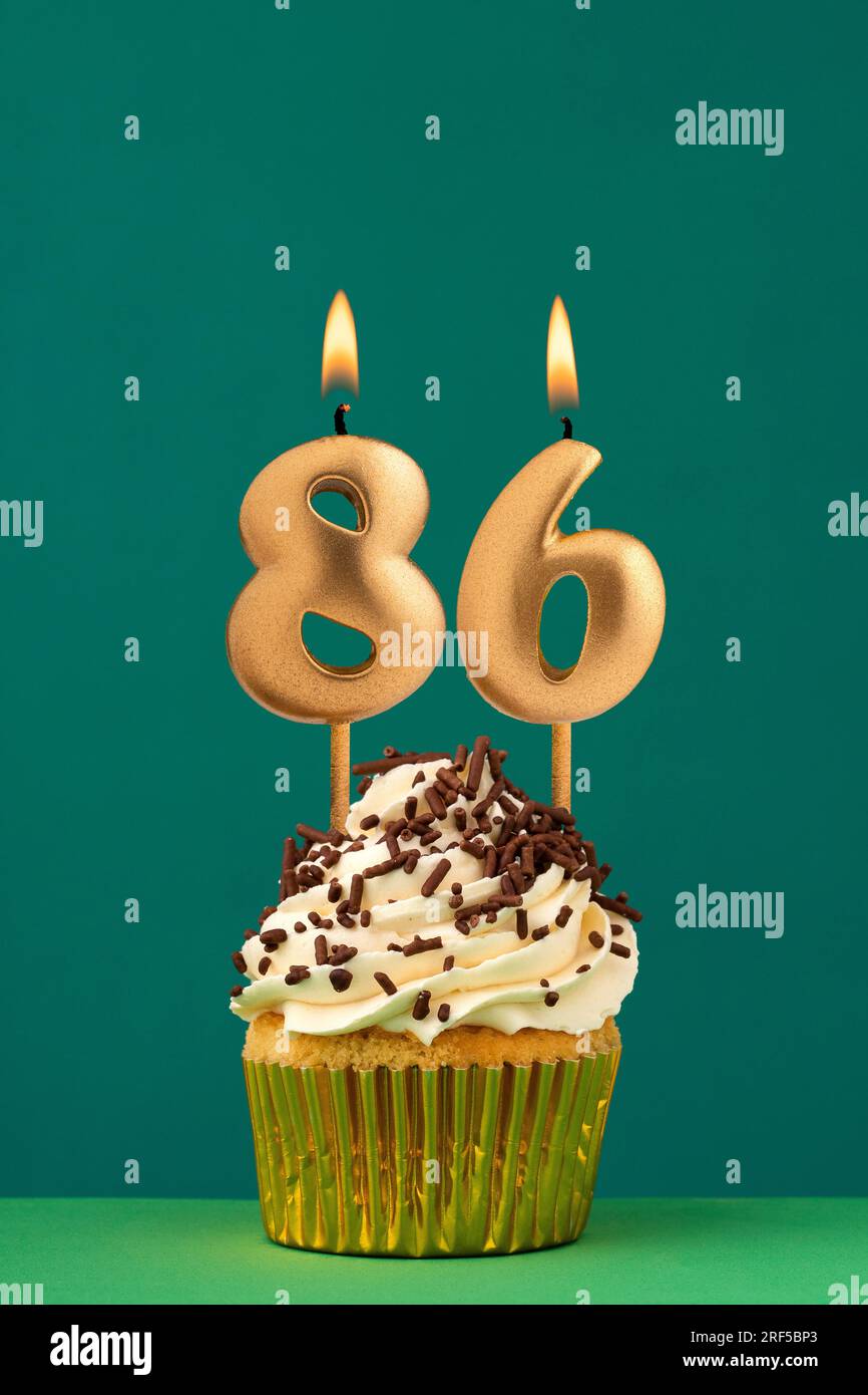 Birthday card with candle number 86 - Green background Stock Photo - Alamy