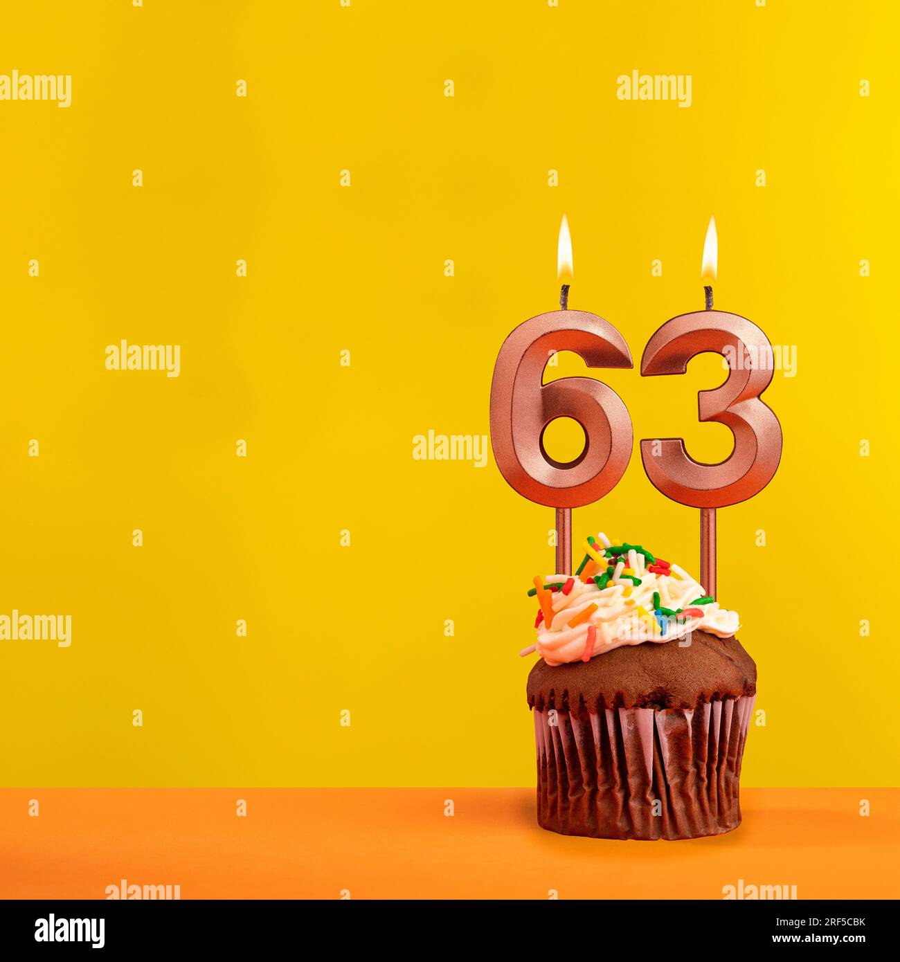 Candle with flame number 63 - Birthday card on yellow background Stock ...