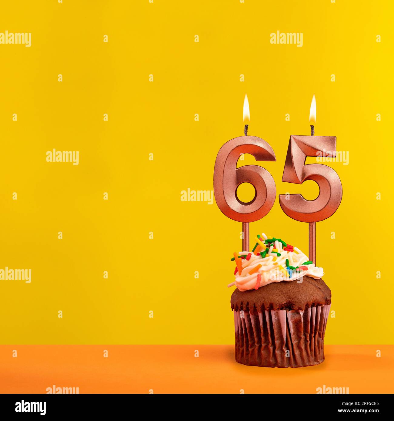 Candle with flame number 65 - Birthday card on yellow background Stock ...