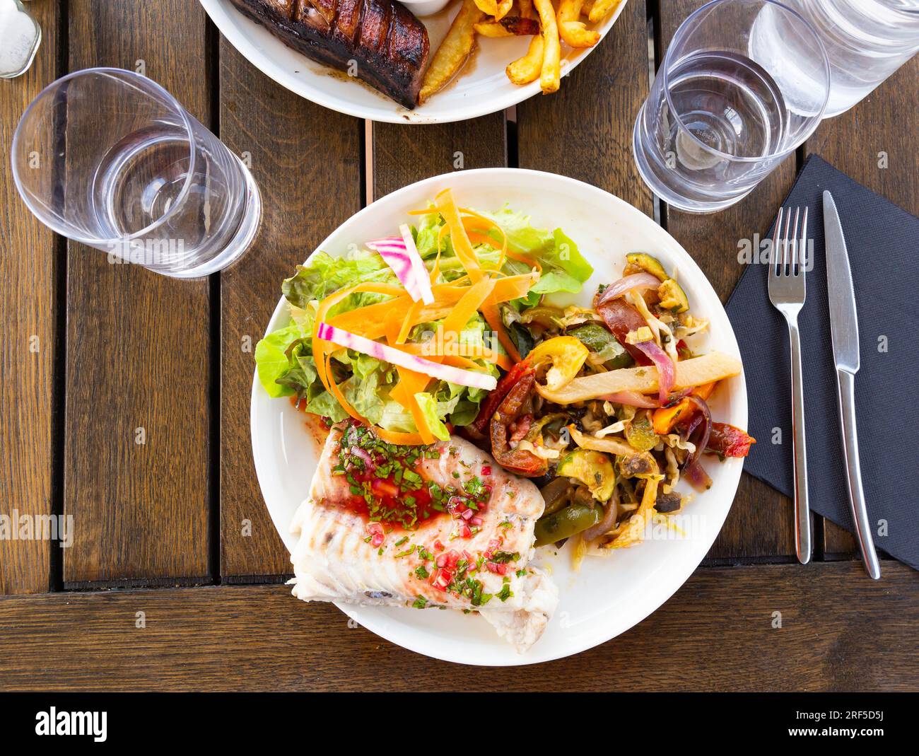 French-style molva or sea pike with vegetables. French cuisine Stock ...