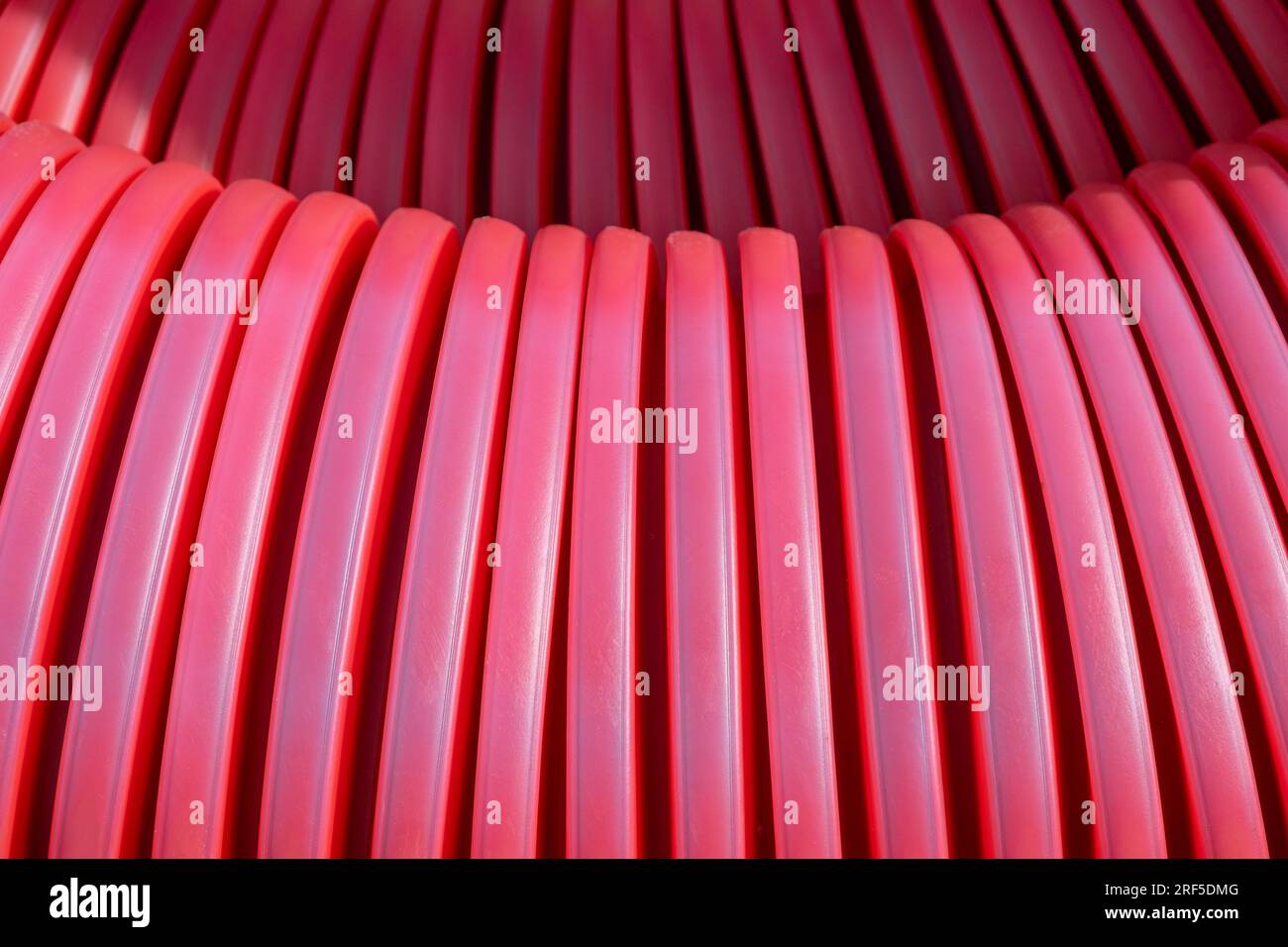 red corrugated PVC pipe cover protection for electric cables. macro ...