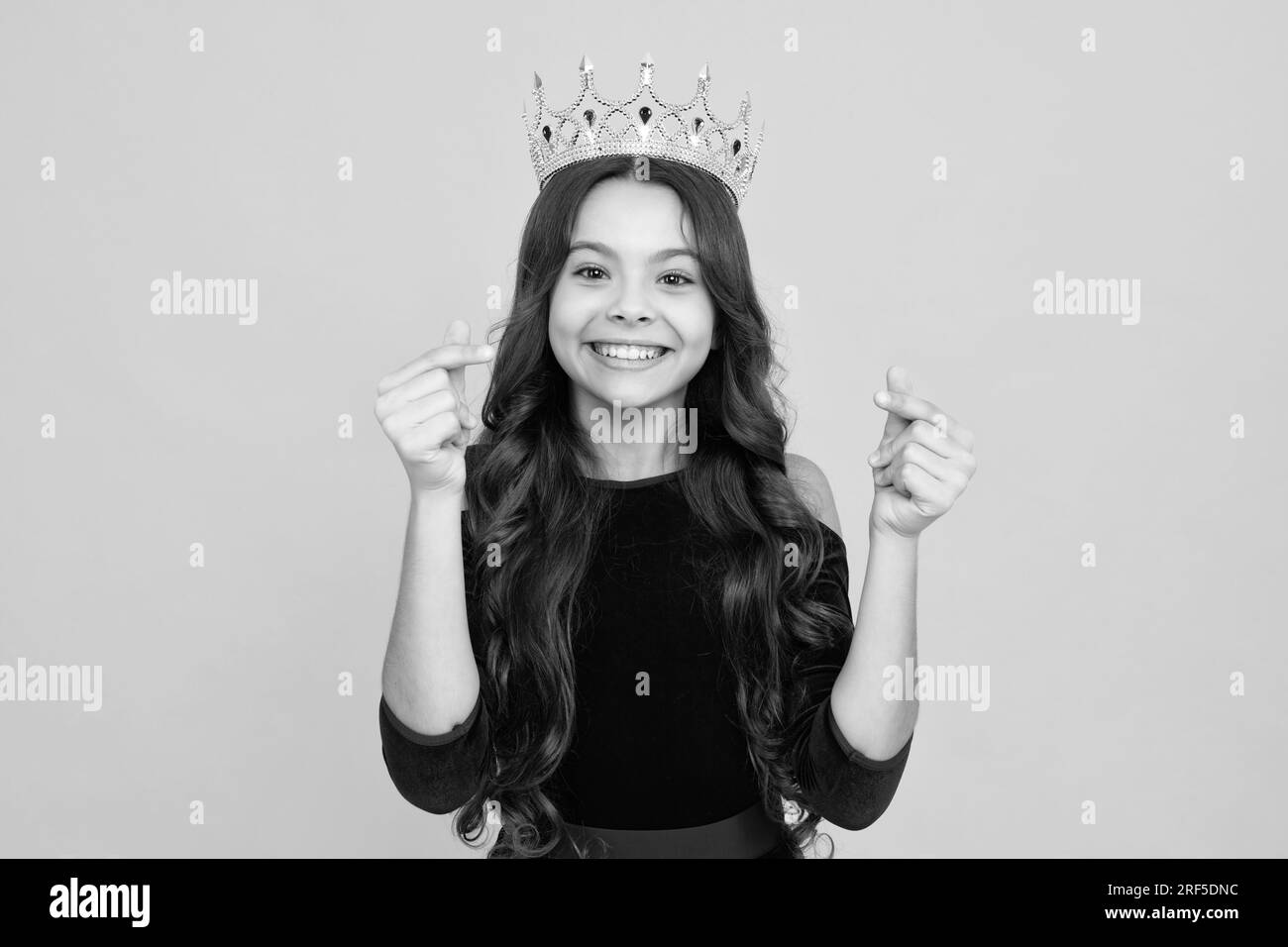 Little queen wearing golden crown. Teenage girl princess holding crown ...