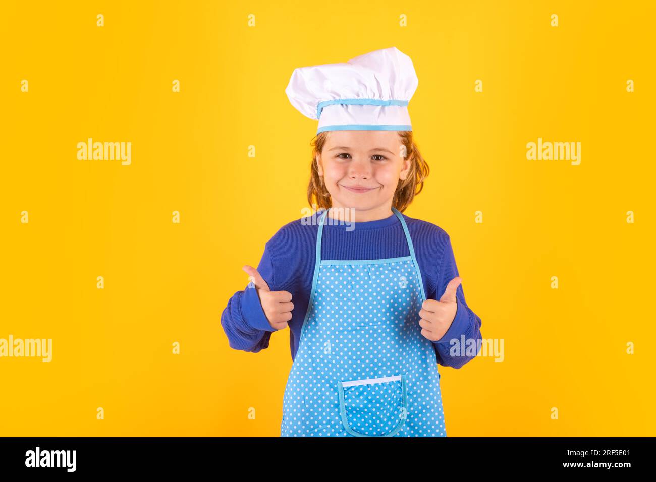 Chef kid boy making healthy food. Portrait of little child in chef hat ...
