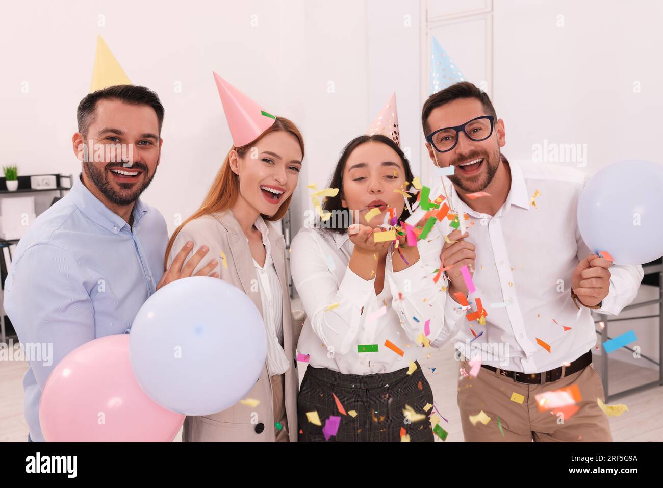 Coworkers having fun during office party indoors Stock Photo - Alamy