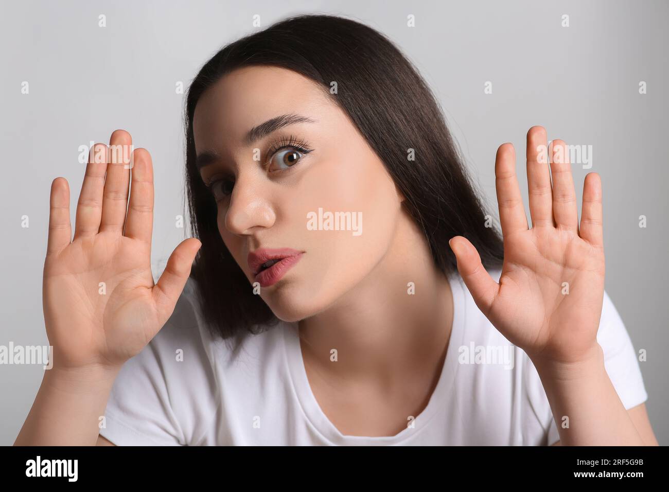 Shocked young woman stuck to transparent screen. Internet addiction ...