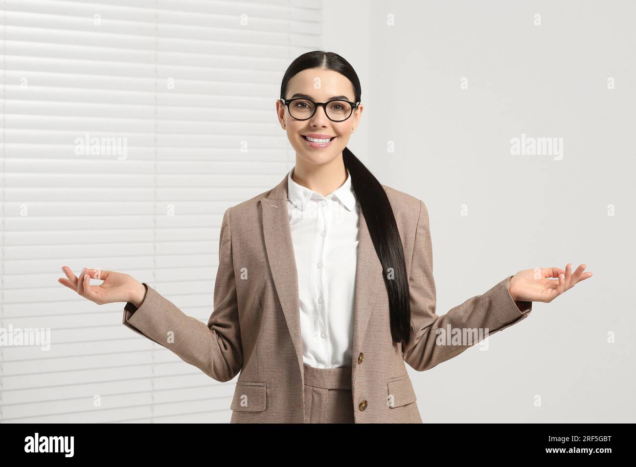 Beautiful real estate agent in nice suit indoors Stock Photo - Alamy