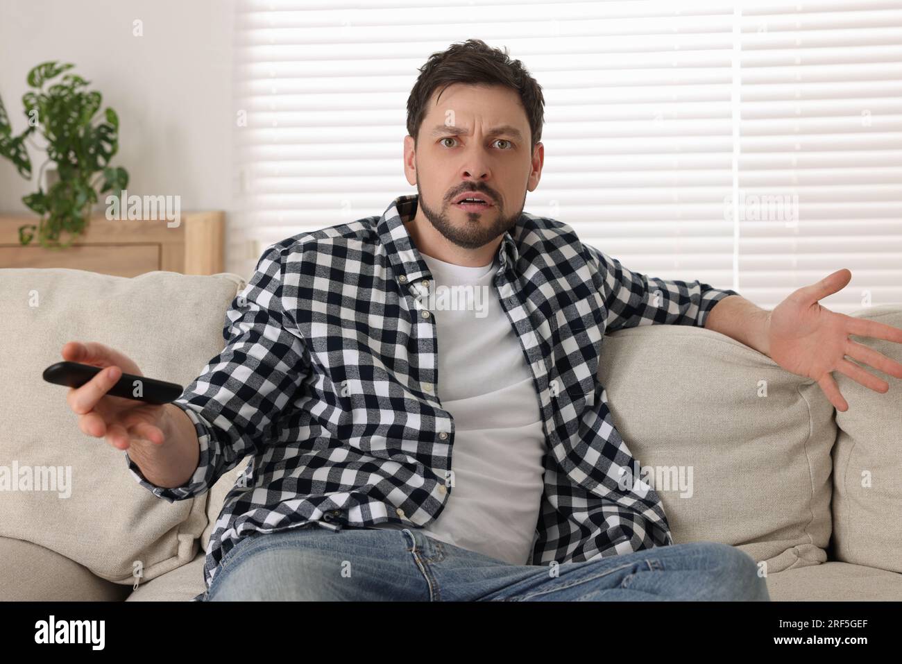 Remote control television frustrated hi-res stock photography and ...