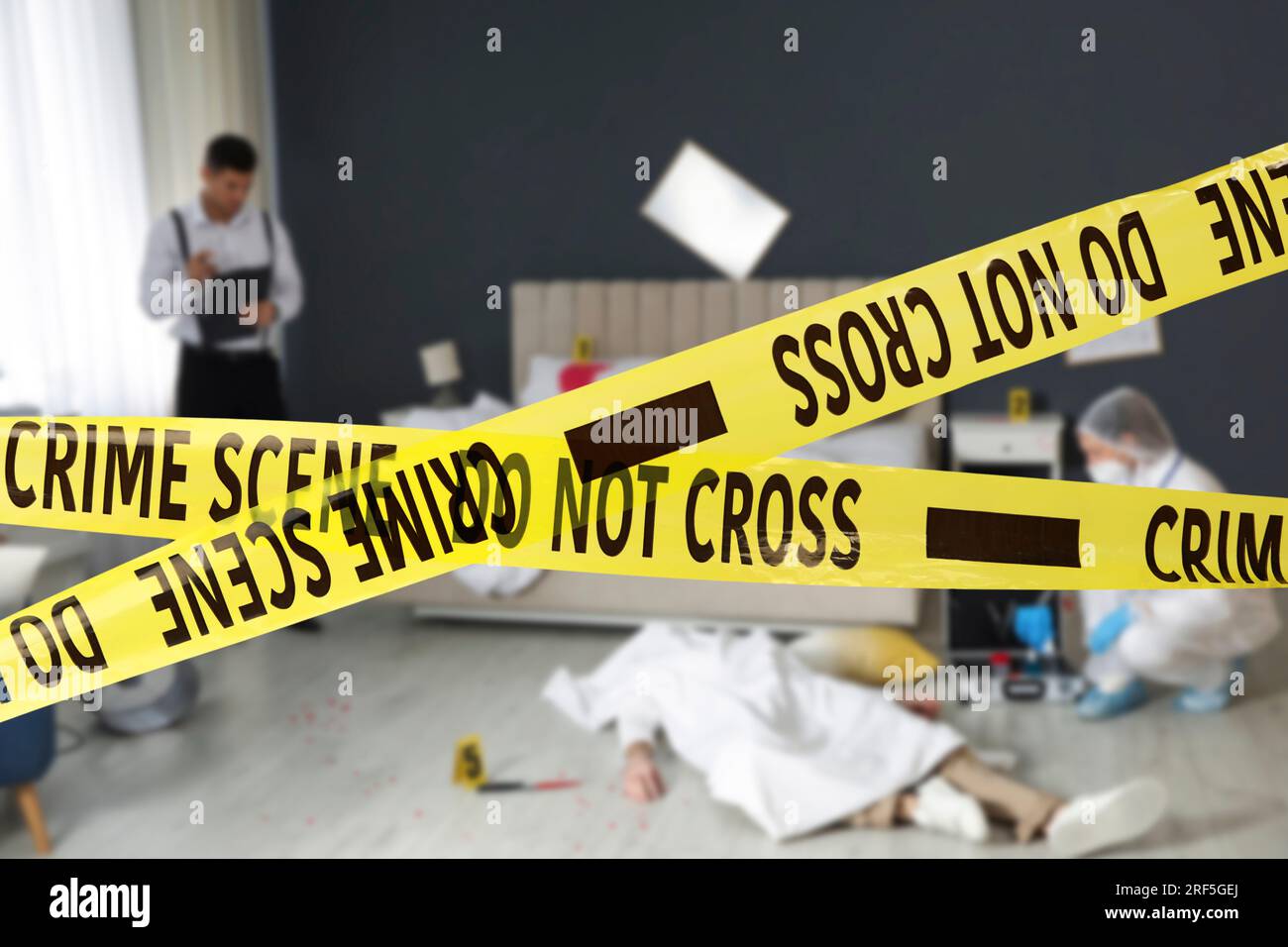 Yellow tapes blocking way to crime scene. Investigator and ...