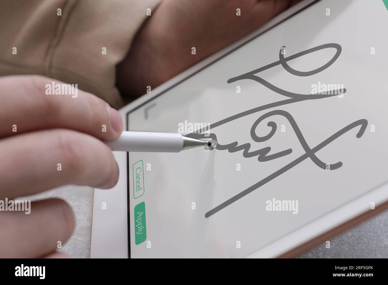 Electronic signature. Man using stylus and tablet, closeup Stock Photo ...