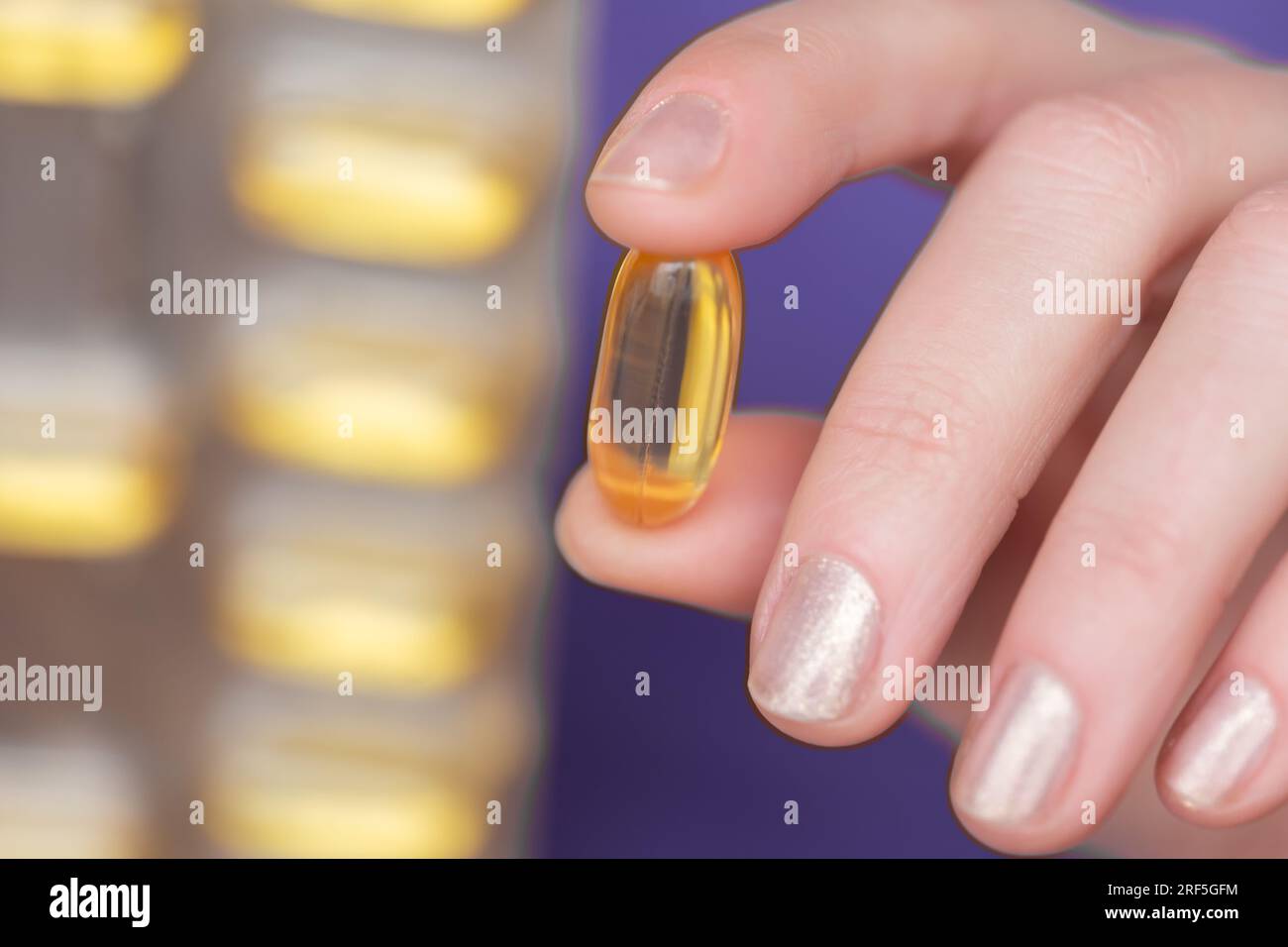 Omega fatty acids capsules.Fish oil capsules in hands.Healthy fats and ...