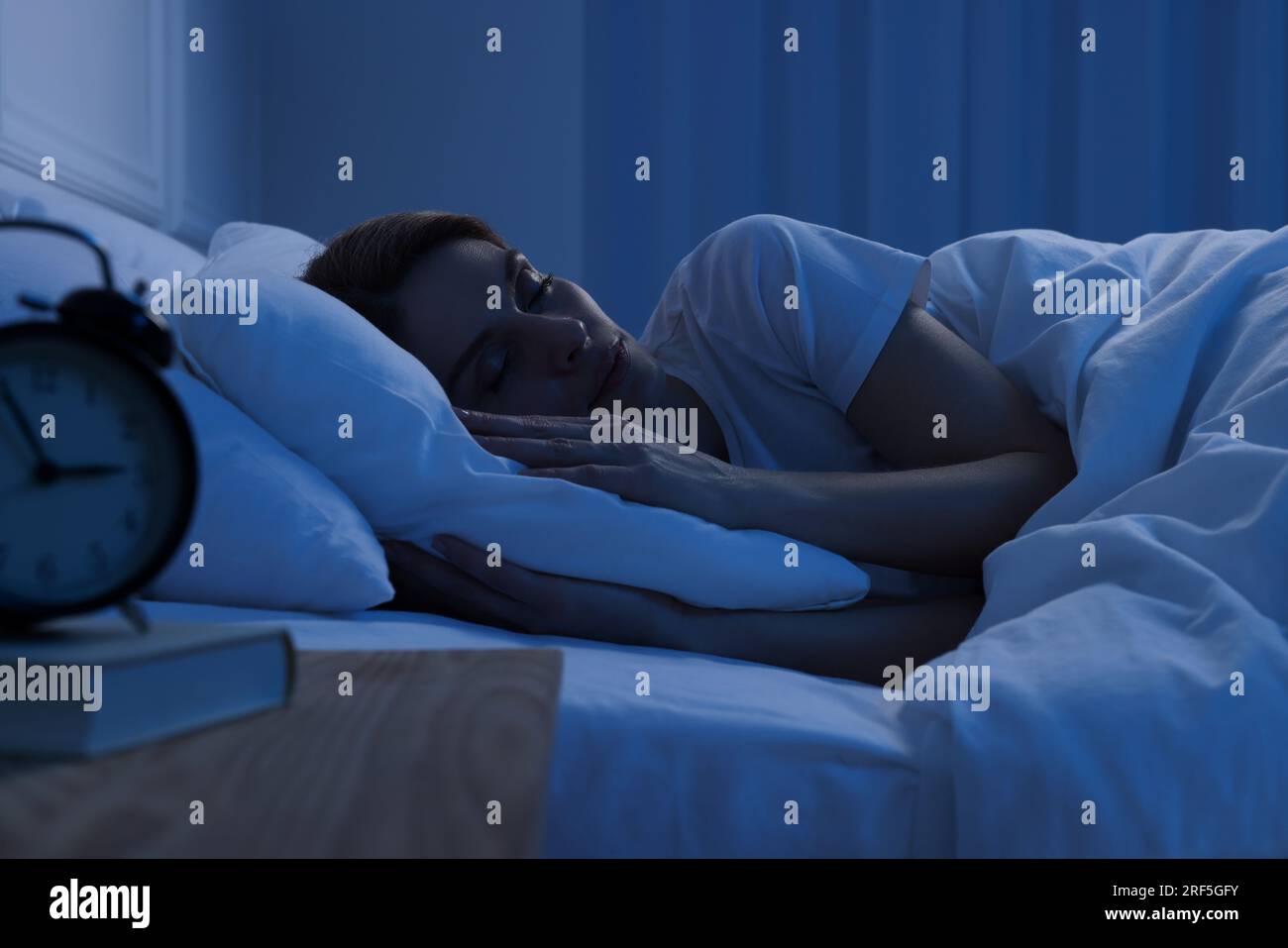 Handsome man sleeping in bed at night Stock Photo - Alamy