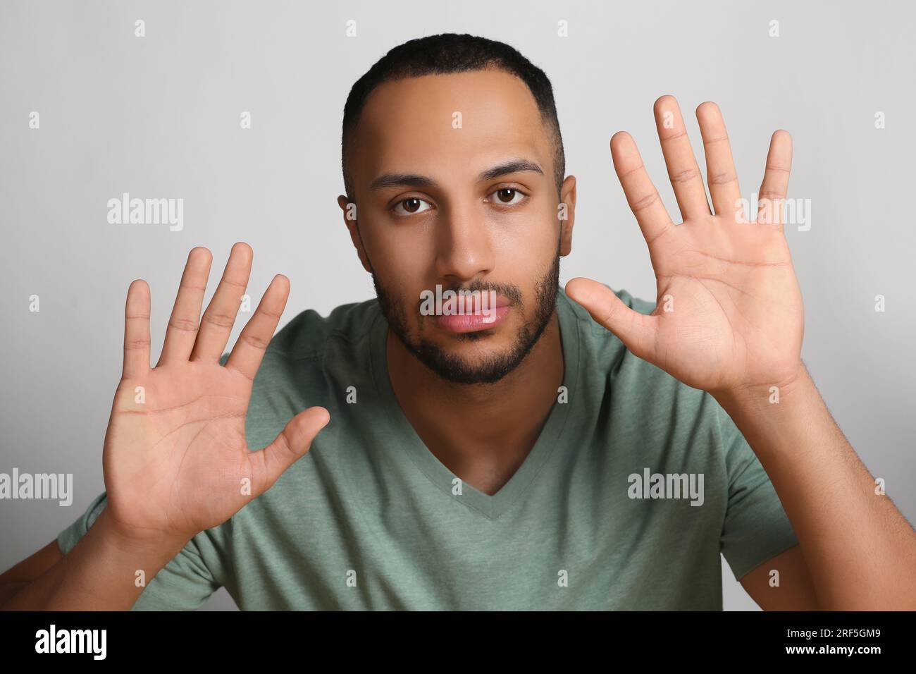 Young man stuck to transparent screen. Internet addiction concept Stock ...