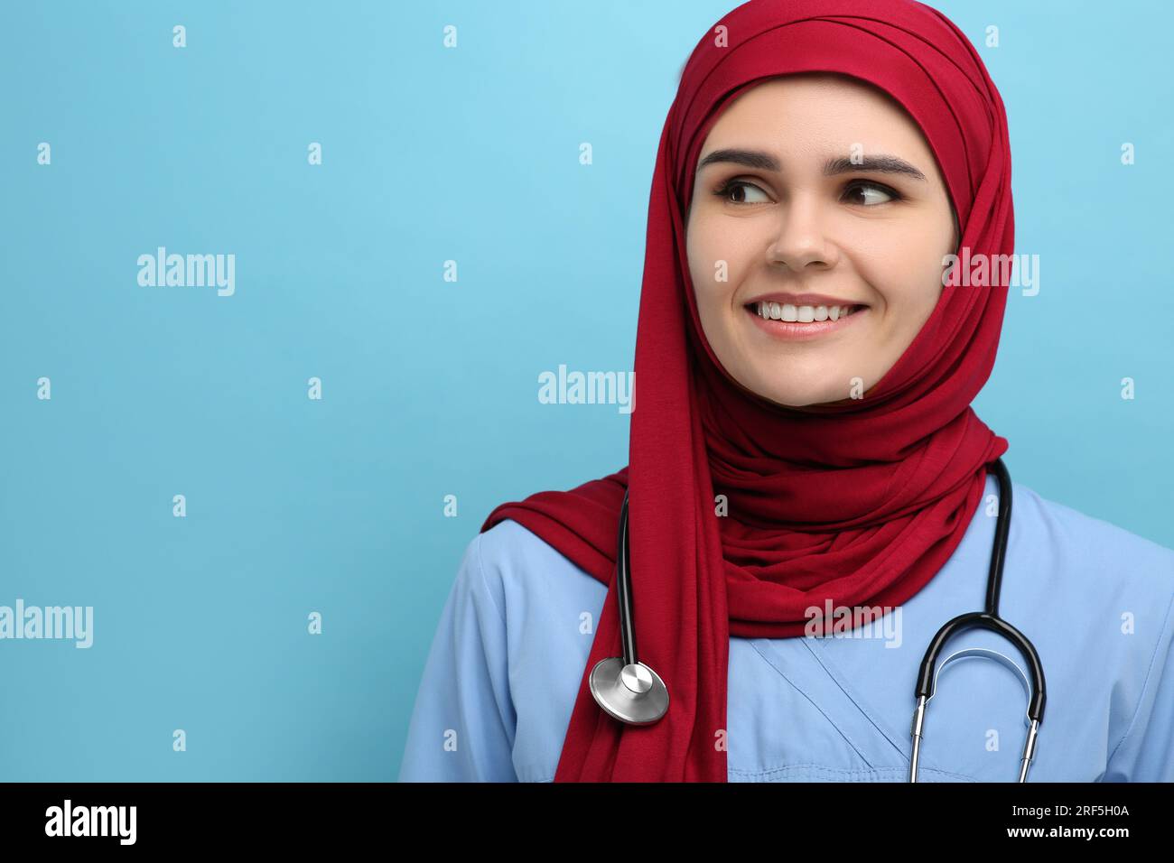 Muslim woman wearing hijab and medical uniform with stethoscope on ...