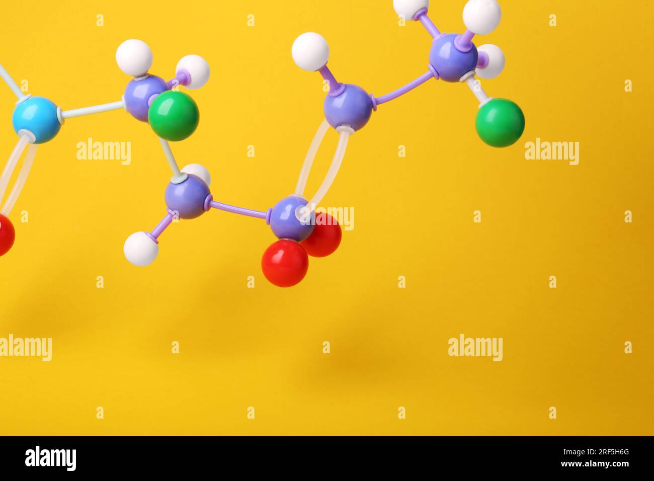 Structure of molecule on yellow background, closeup and space for text ...