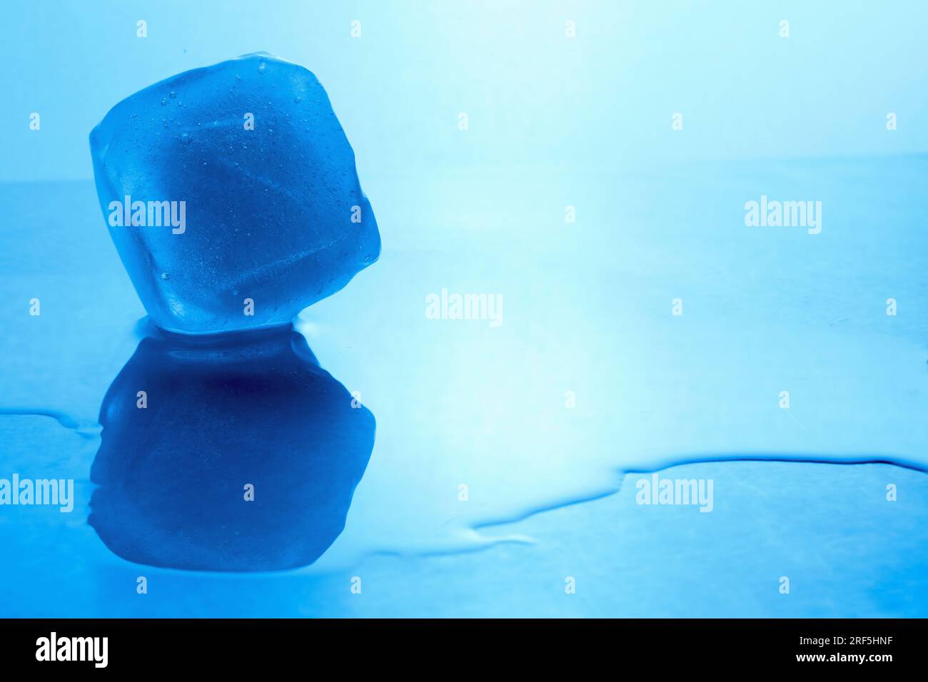 Crystal clear ice cube on light blue background, space for text. Color tone effect Stock Photo ...